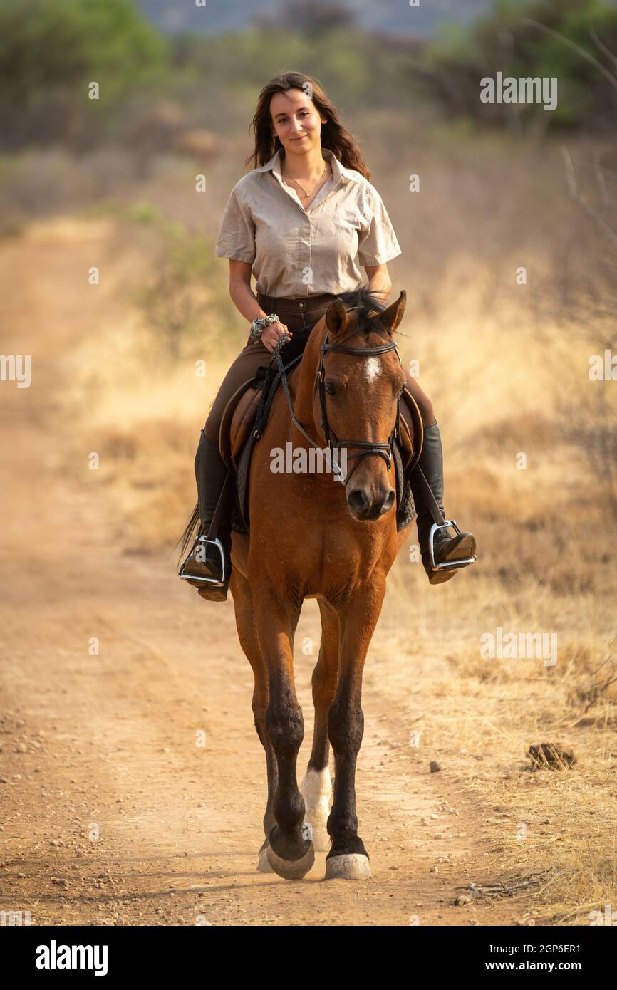 Pretty horsewoman riding dark horse hi-res stock photography and images ...