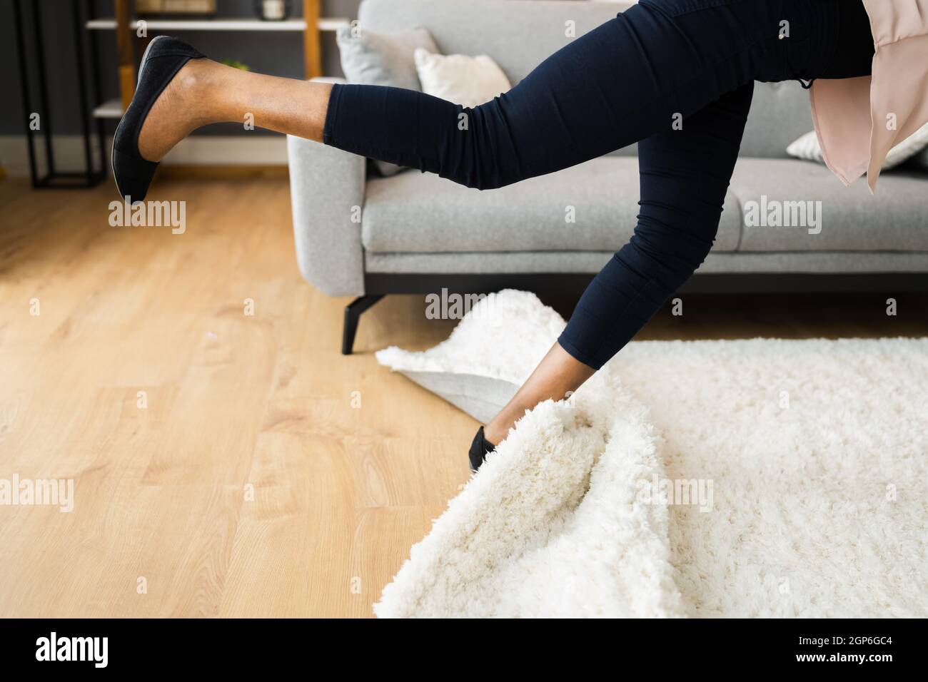 Falldown Hazard. Clumsy Woman Stumbled On Rug Stock Photo - Alamy