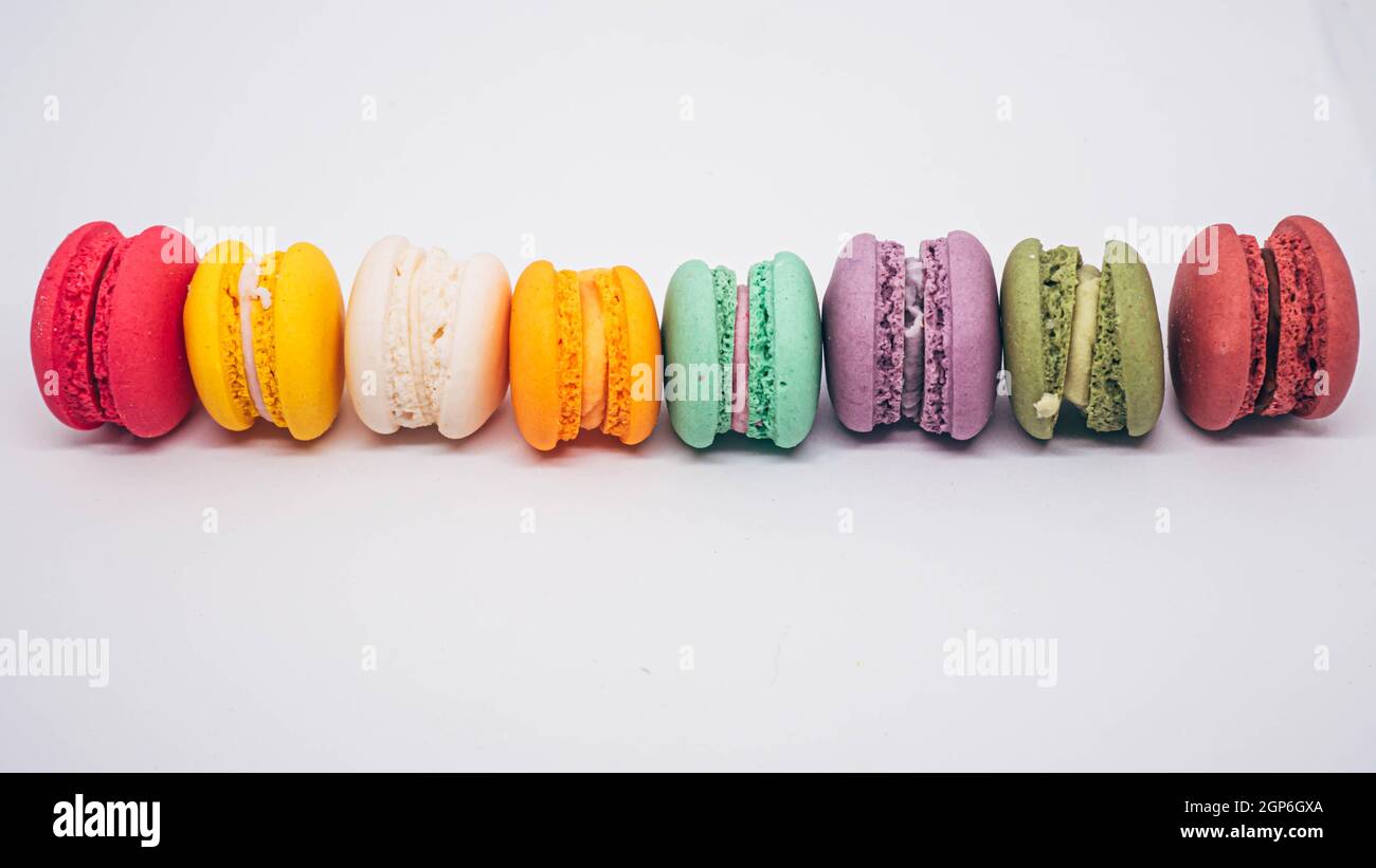 Pastel colored macarons sweet French dessert isolated on white ...