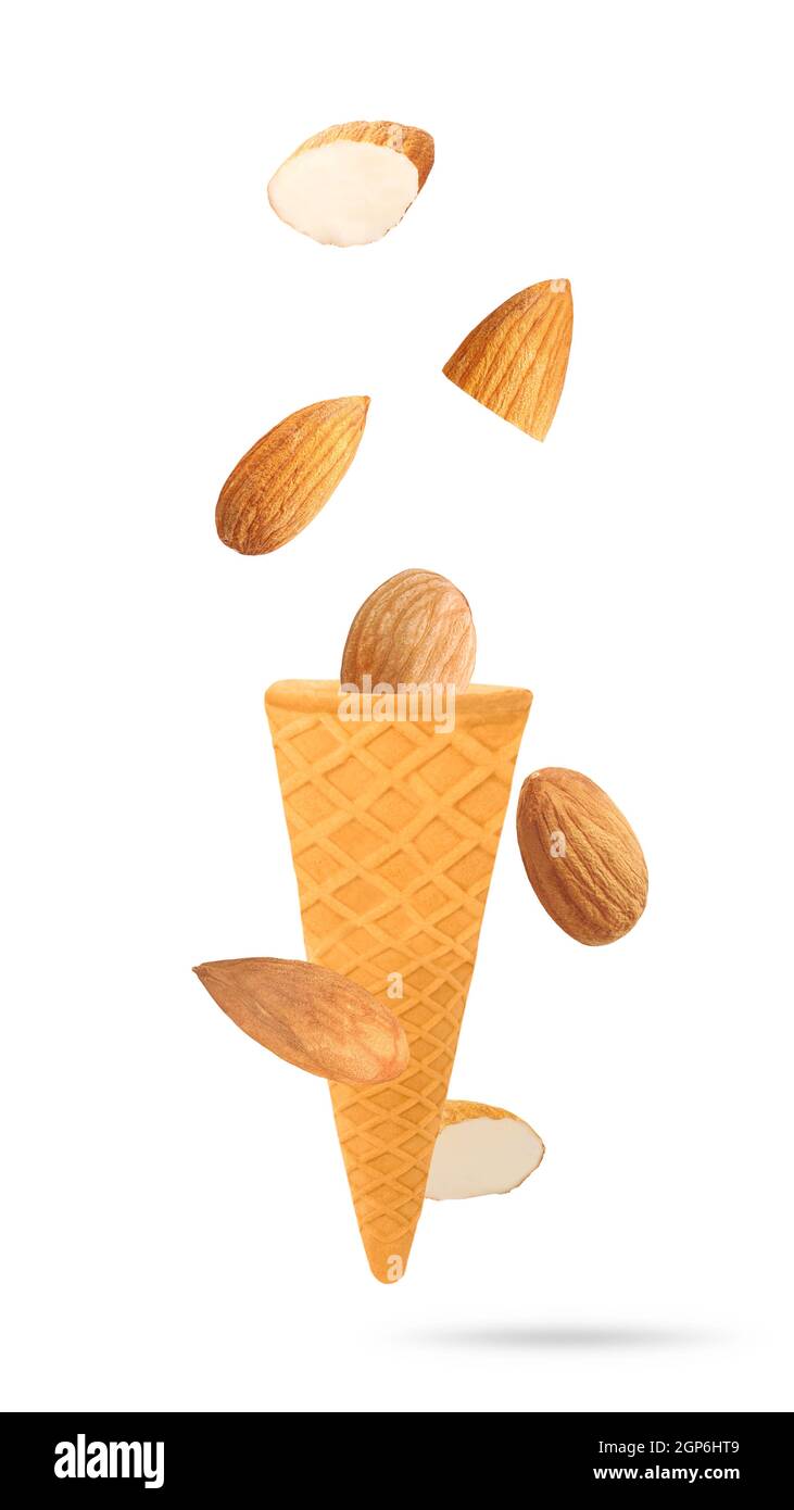 Isolated flying nuts. Seven whole and slices of almonds falling down in ...