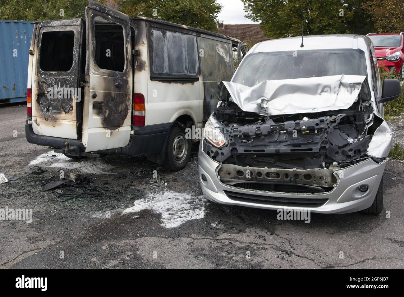 Remains of a burnt van and crashed van outdoors Stock Photo - Alamy