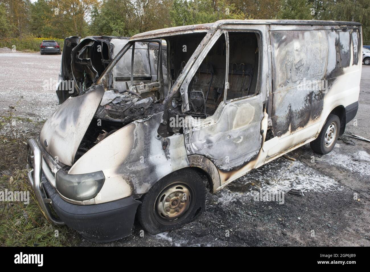 Horizontal shot of Remains of a burnt white van outdoors Stock Photo ...