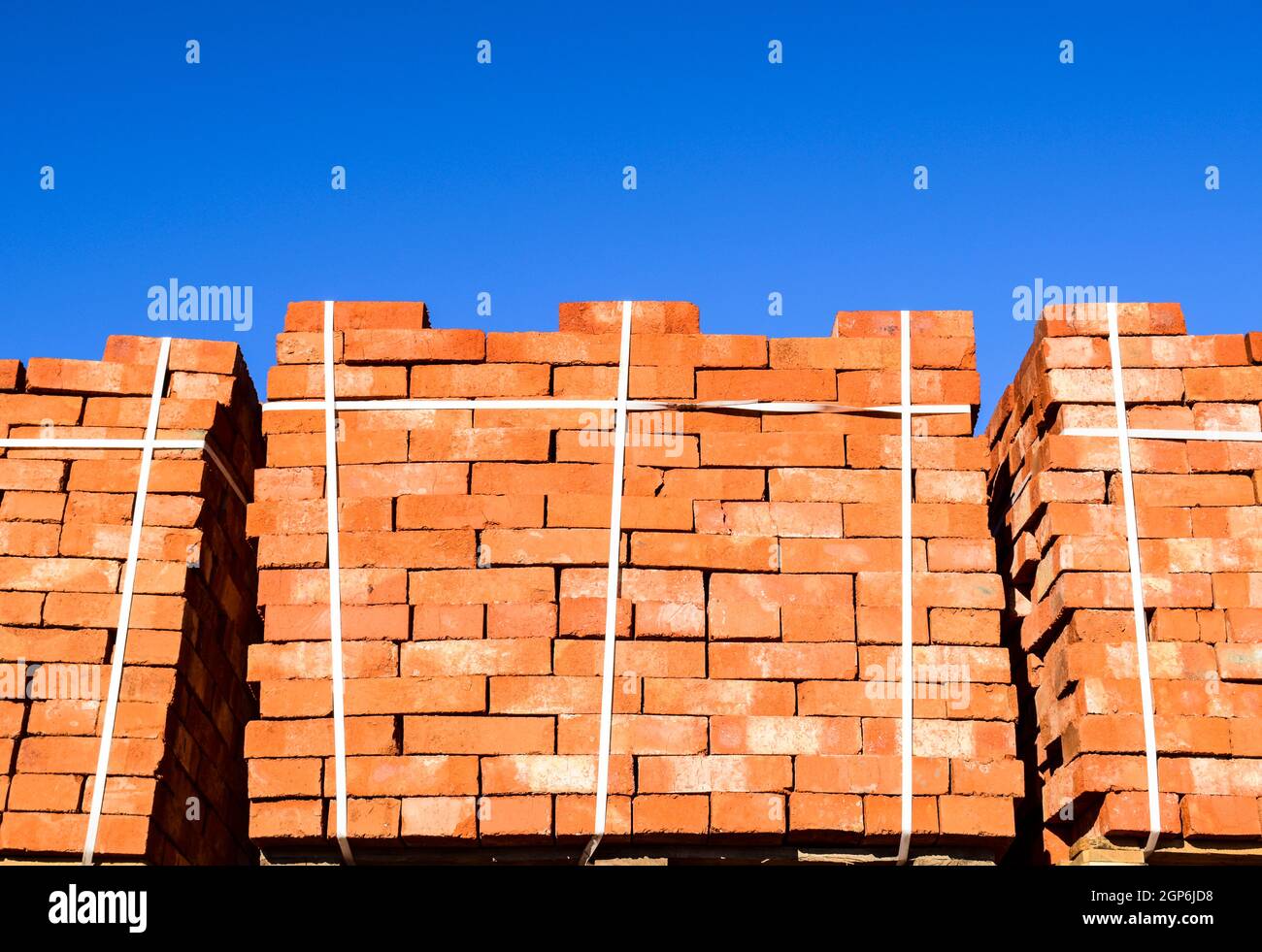 Red bricks stacked into cubes. Warehouse bricks. Storage brickworks ...