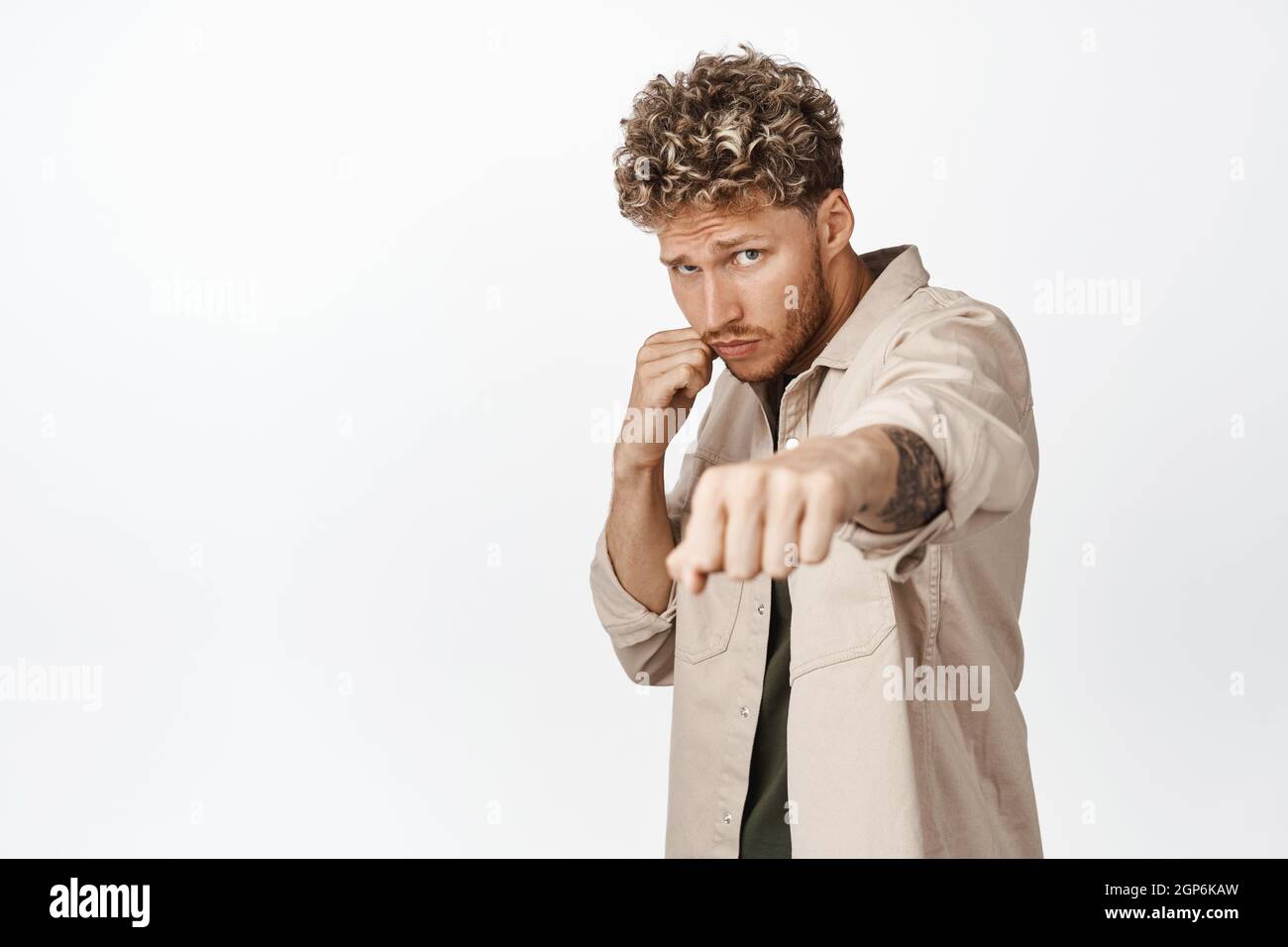 Sassy handsome man punching, clench fist and shadow boxing, fighting ...