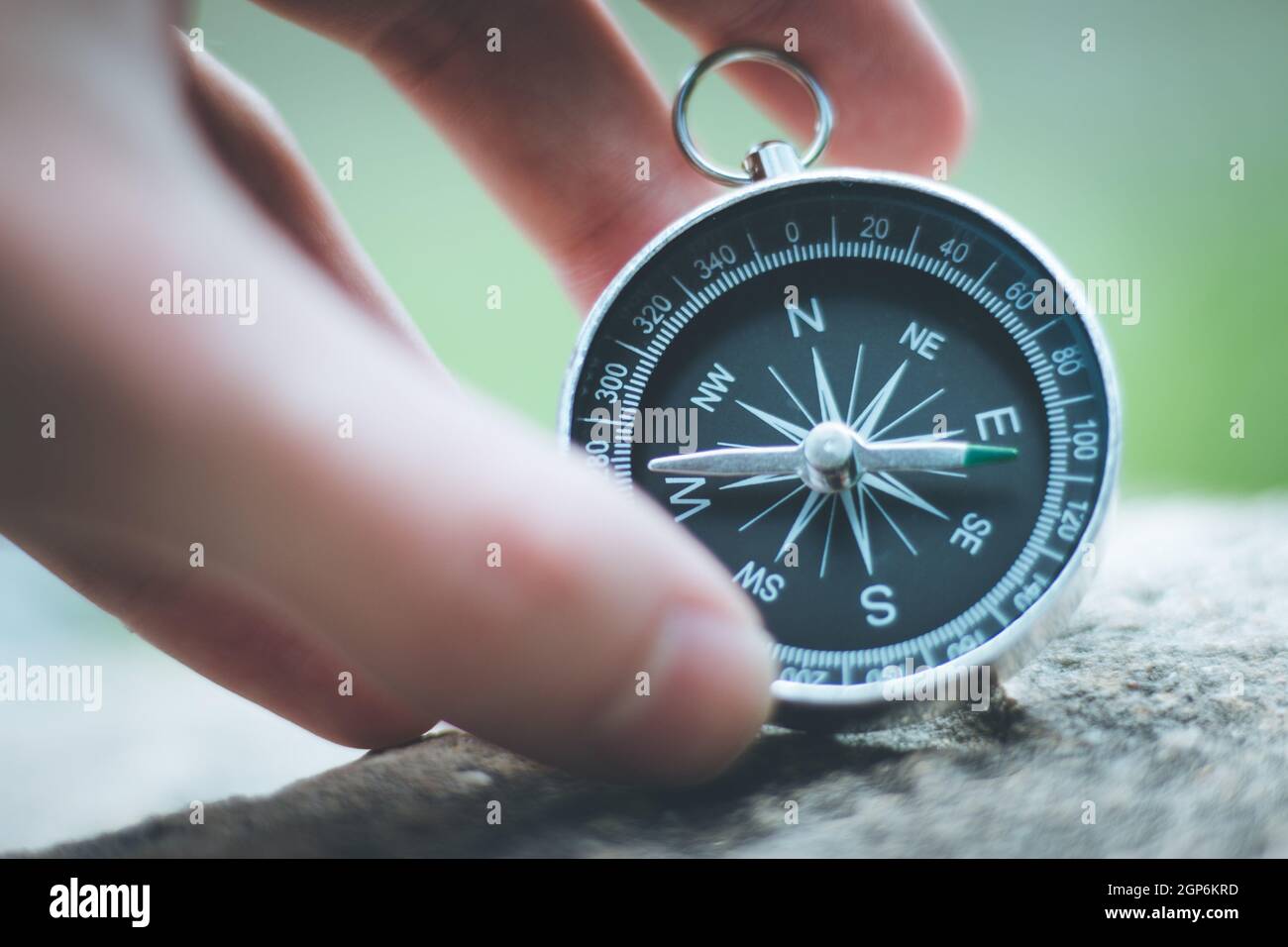 Vintage compass lying on the floor. Adventure and discovery concept ...