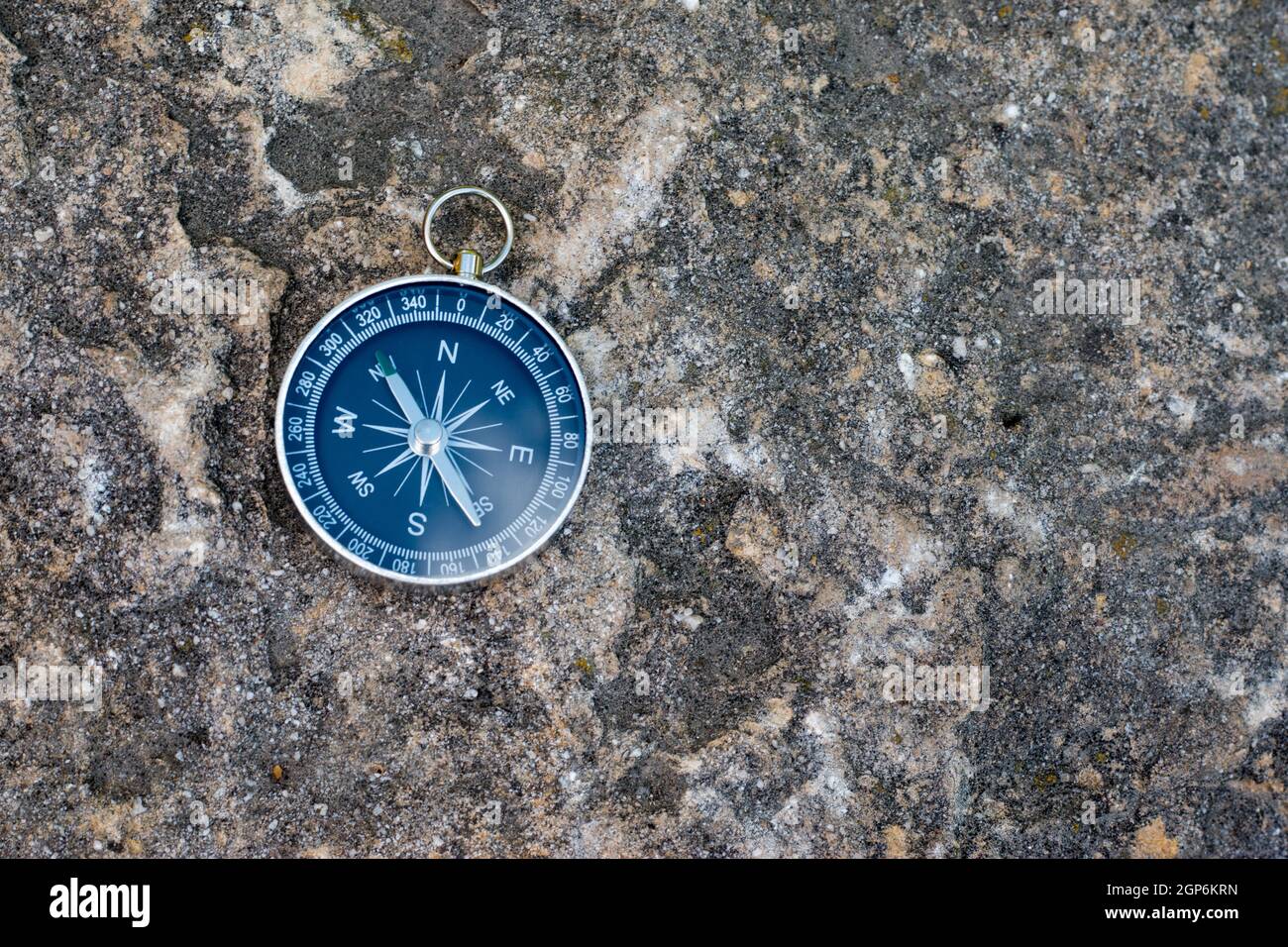 Vintage compass lying on the floor. Adventure and discovery concept ...