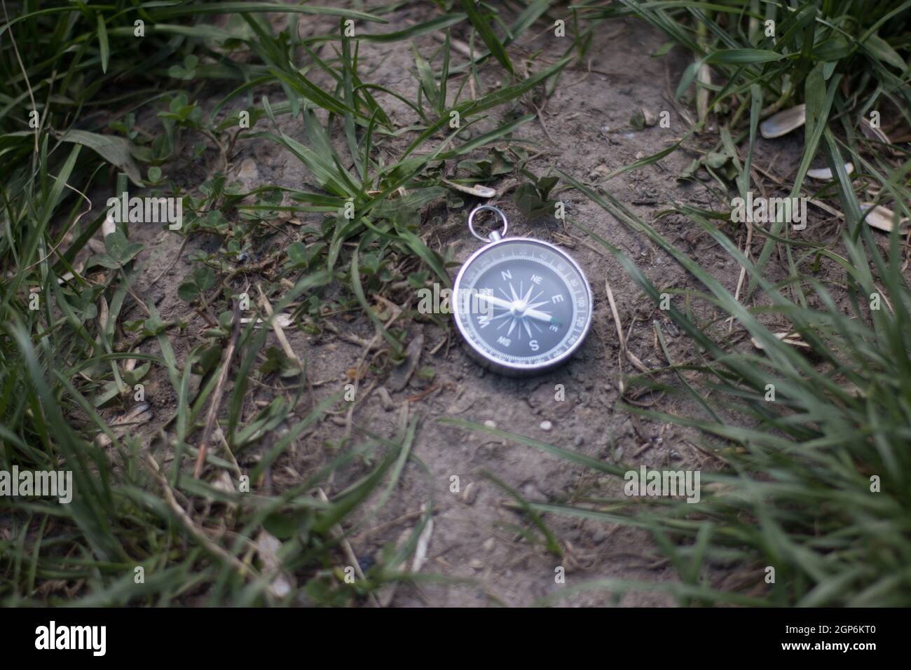 Vintage compass lying on the floor. Adventure and discovery concept ...