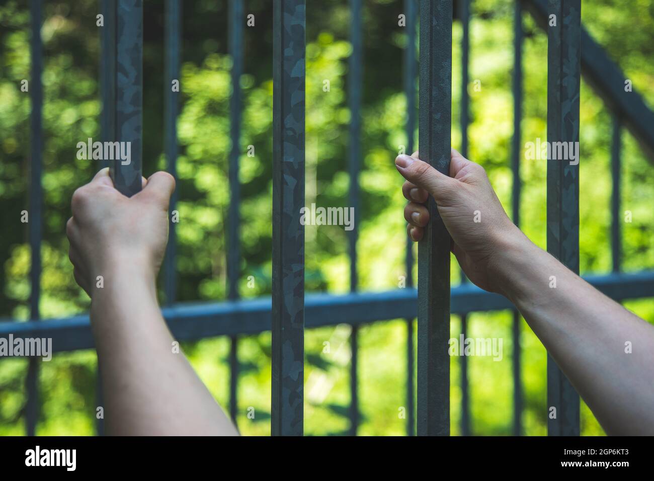 Close up of hands in a prison cell, jail Stock Photo - Alamy