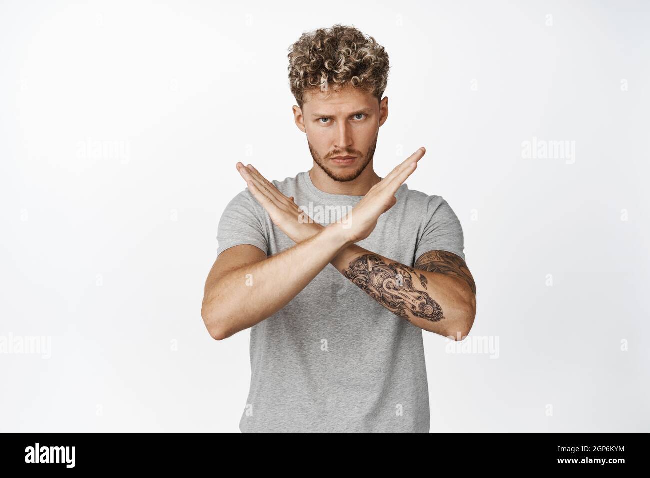 Stop, quit it. Serious and confident man shows cross gesture, say no ...