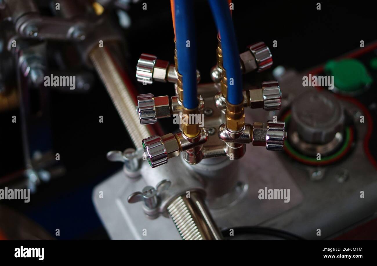 Close-up view of metal rotary round knobs controls of a machine in a ...