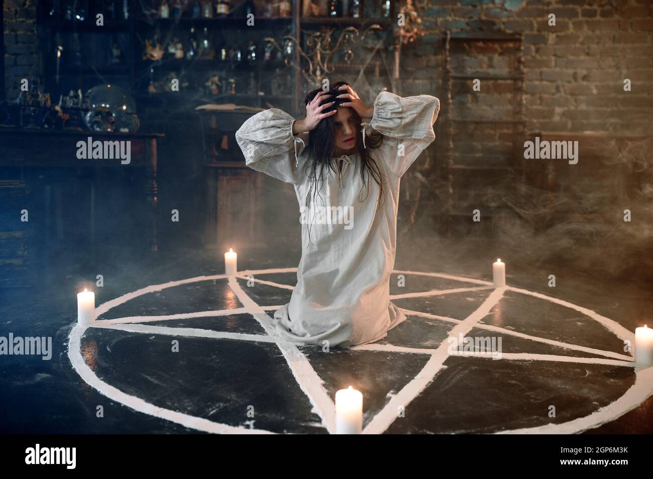 Scary demonic woman sitting in the magic circle, demons casting out ...