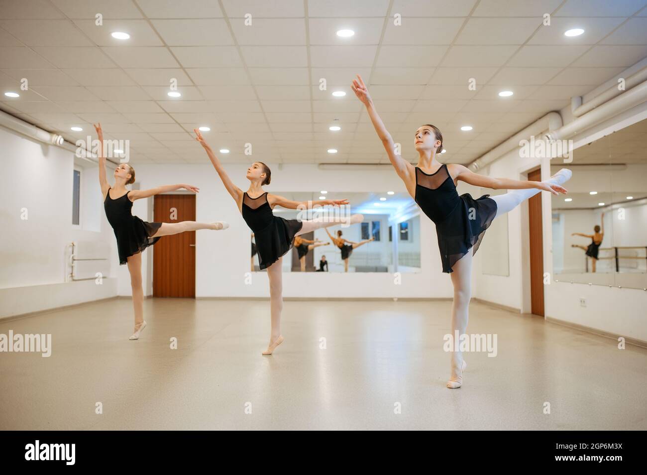Three young ballerinas, teens rehearsing in class. Ballet school ...