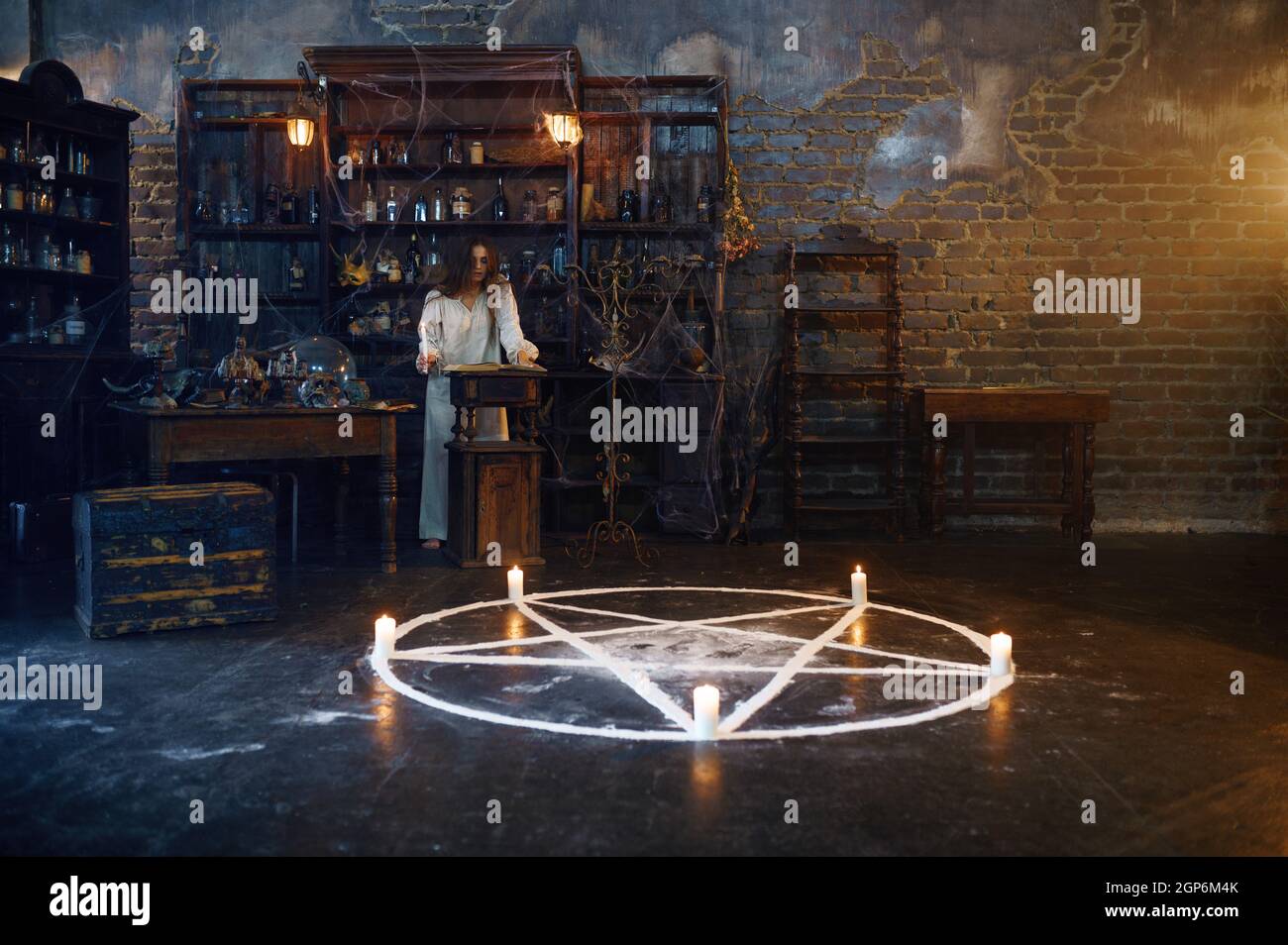 Young demonic woman reads book of spells, demons casting out. Exorcism ...