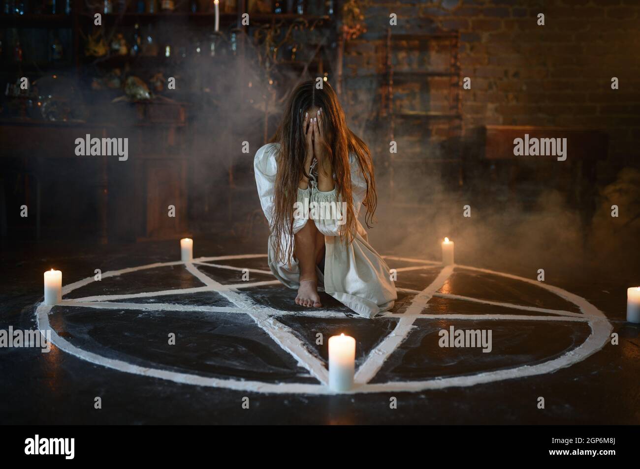 Crazy demonic woman sitting in magic circle with candles, demons ...