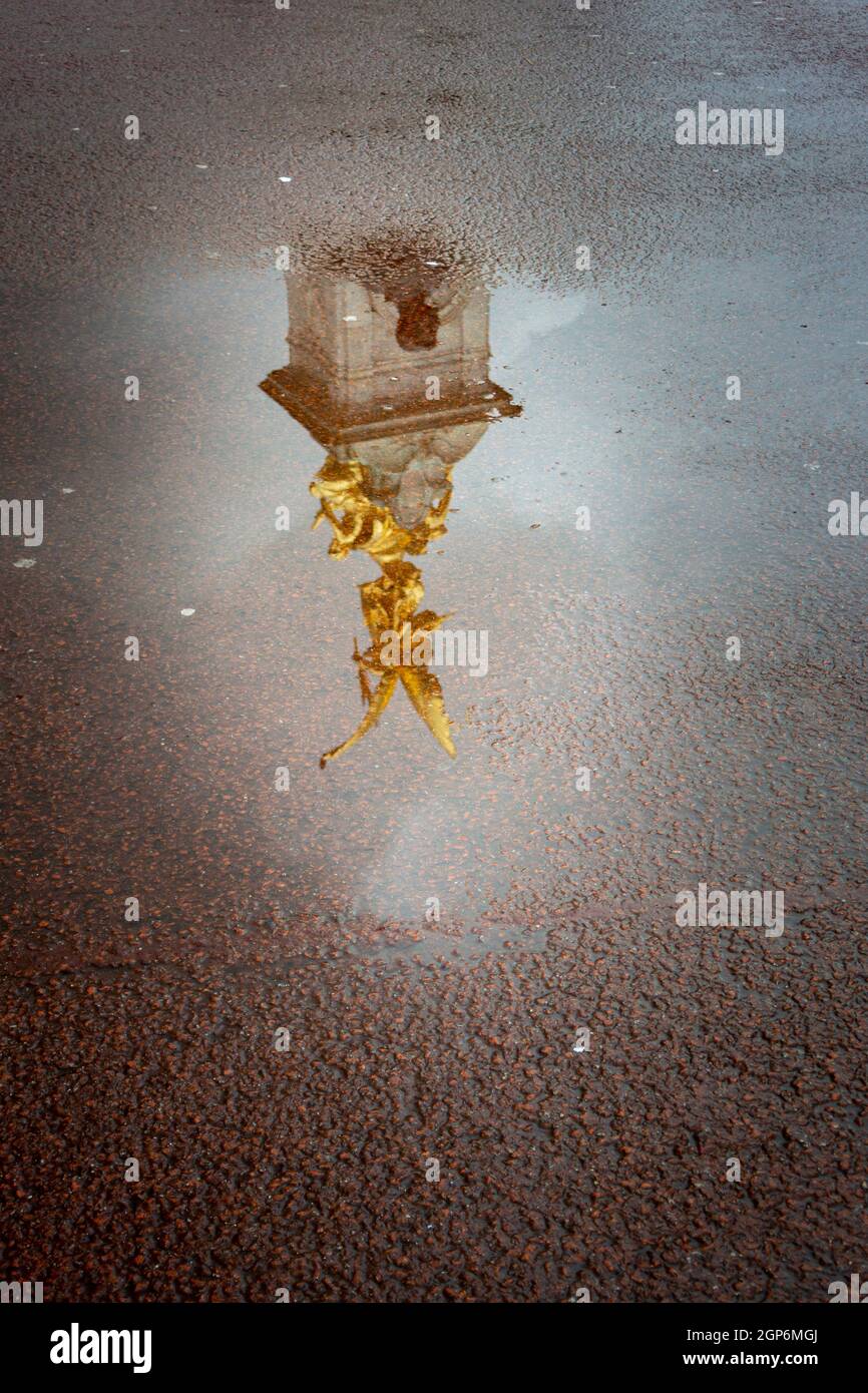 Reflecion in a puddle of the gold Victory Angel of the Vitoria Memorial ...