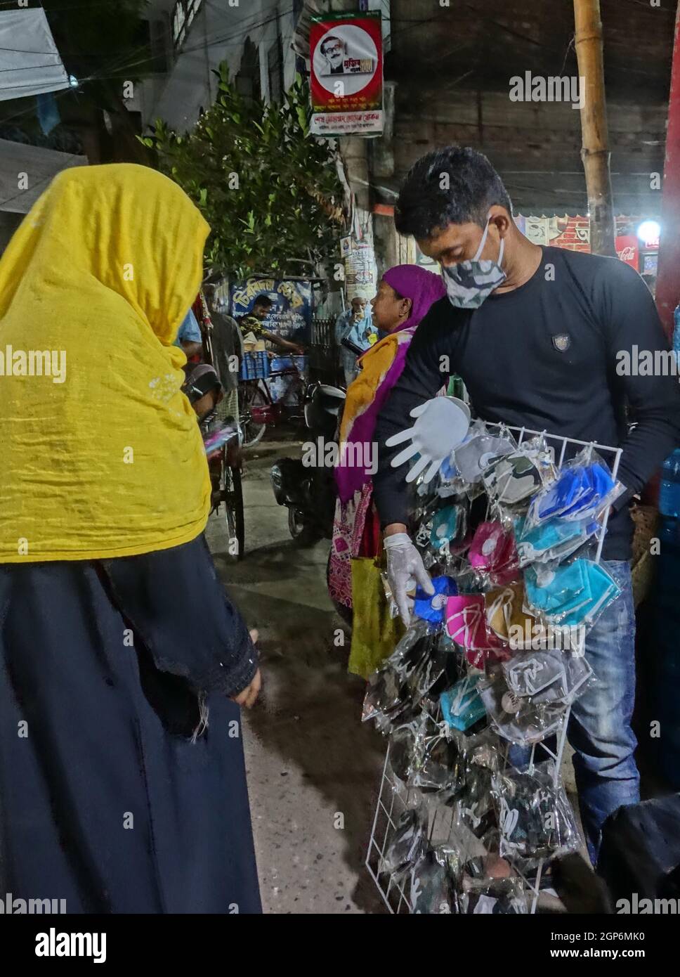 A Bangladesh street vendor selling mask. People wear mask to contain ...