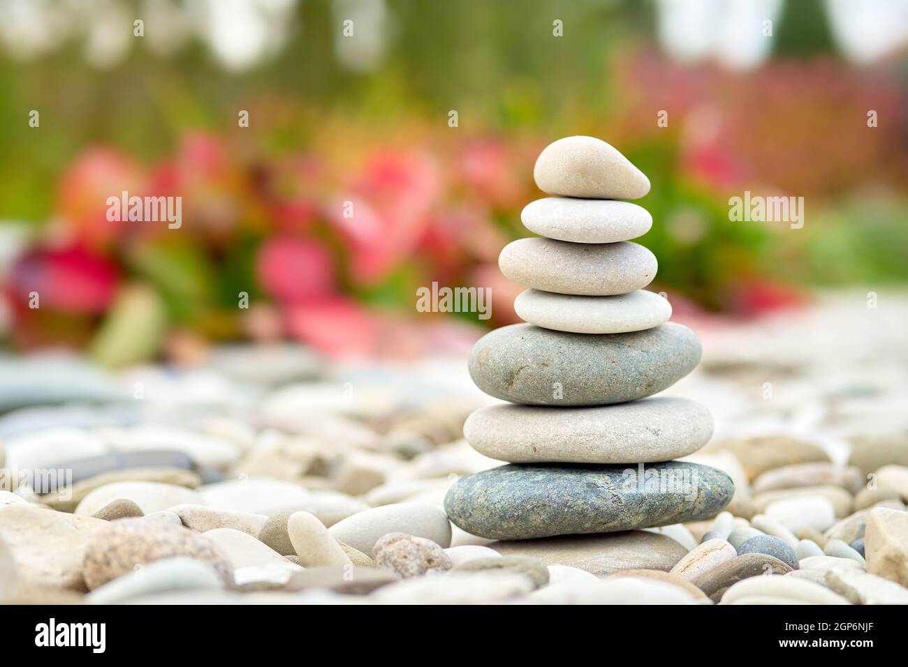 Sea pebbles tower in a garden. Closeup view of stacked jack-stones ...