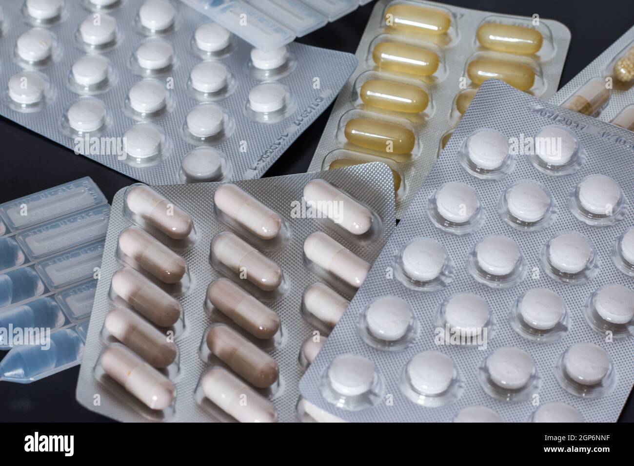 Pills or medicine lying on the grey table, drug abuse Stock Photo - Alamy