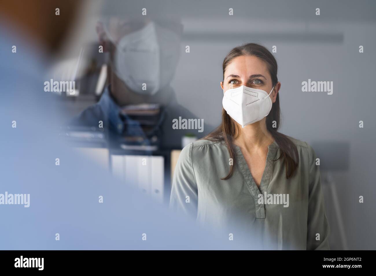 Reception Counter Desk In Covid Face Mask Stock Photo - Alamy