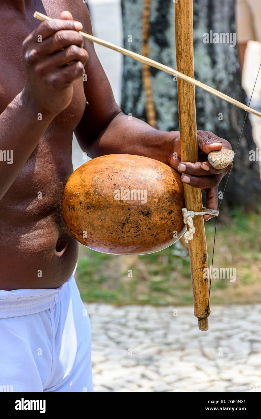 Musician playing a traditional Brazilian percussion instrument called ...