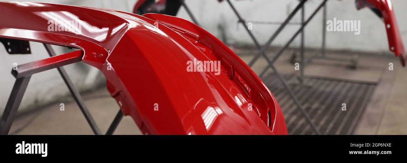 Red plastic car bumper drying after repainting in spraying booth Stock ...