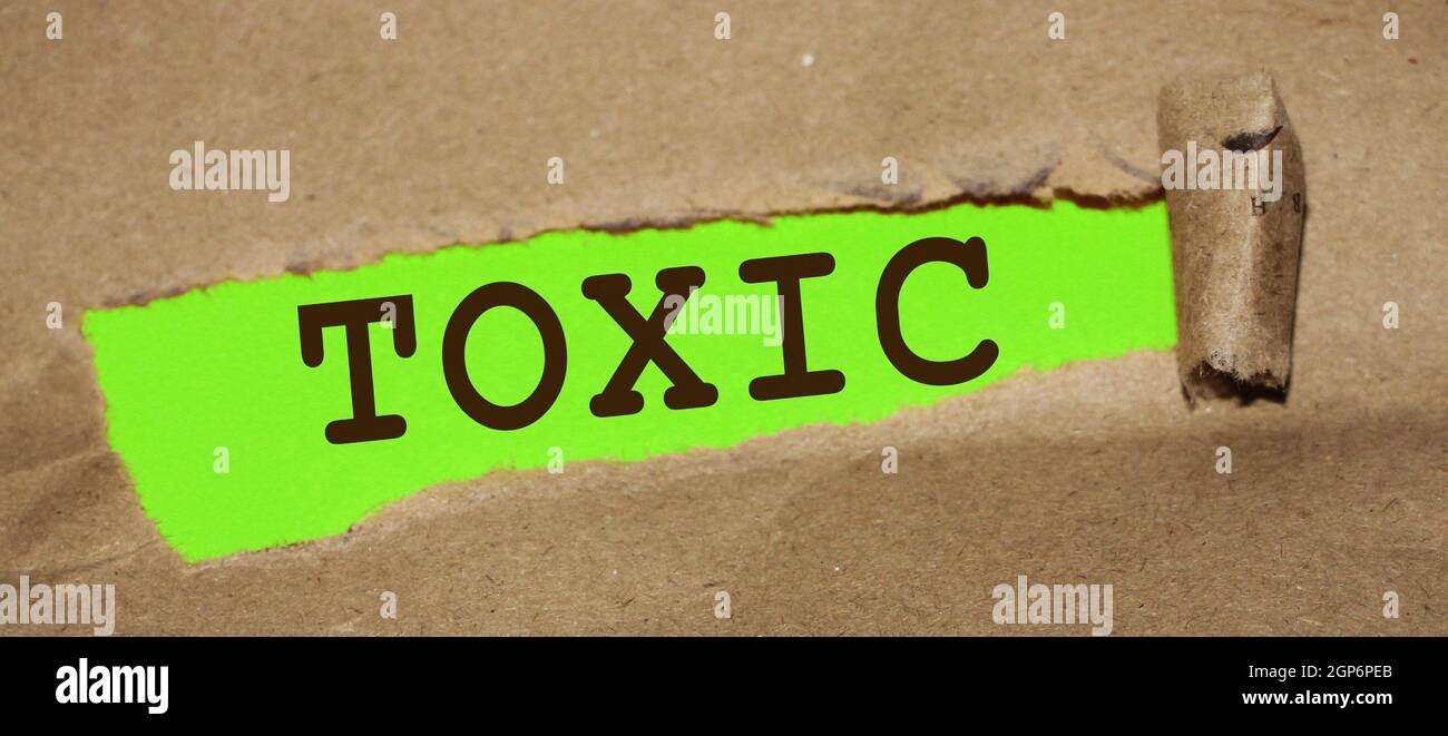 Toxic word uner Brown torn paper with yellow background. Addictions ...