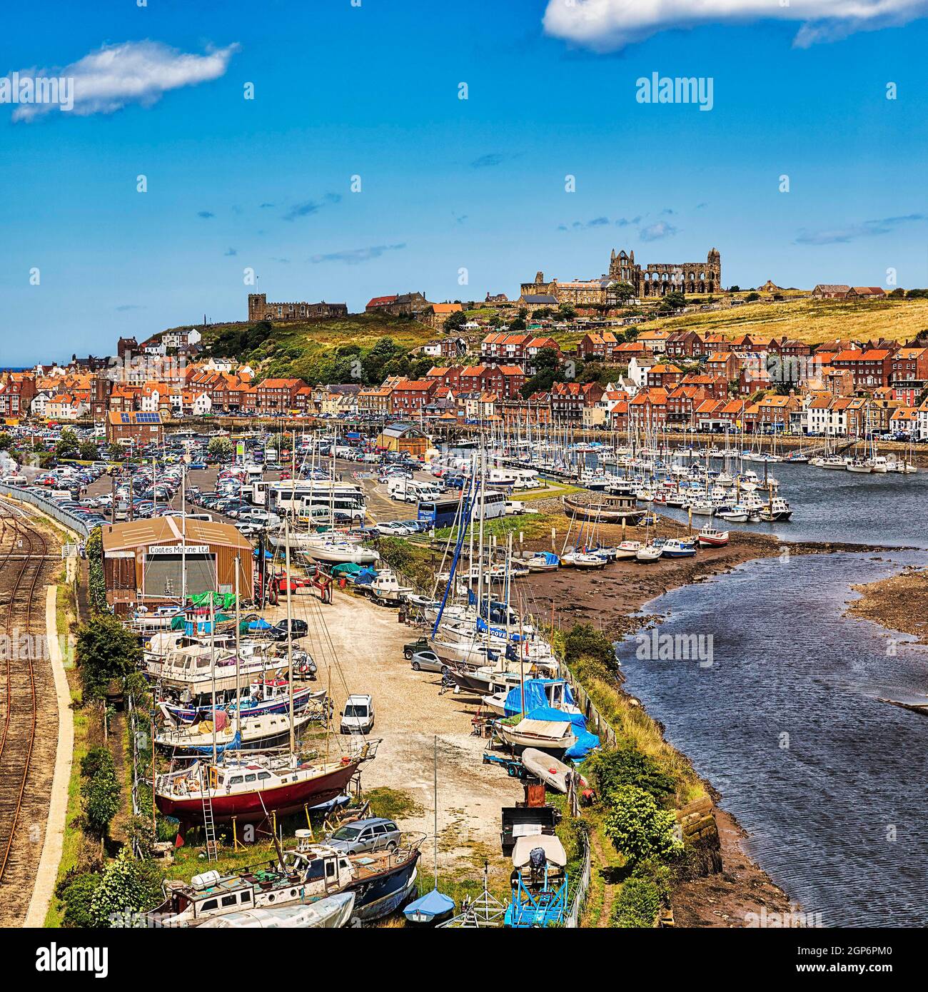 Village view of Whitby with harbour and view of the ruins of Whitby ...