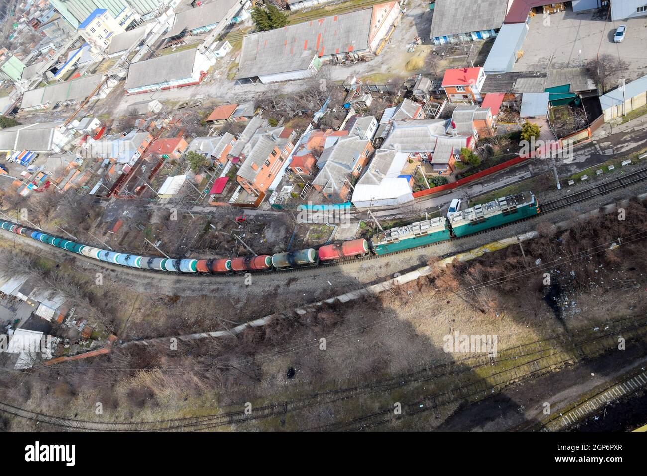 Freight train traveling through the city buildings Stock Photo - Alamy