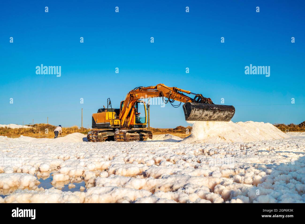 Excavator harvesting sea salt, salt works, Faro, Algarve, Portugal ...