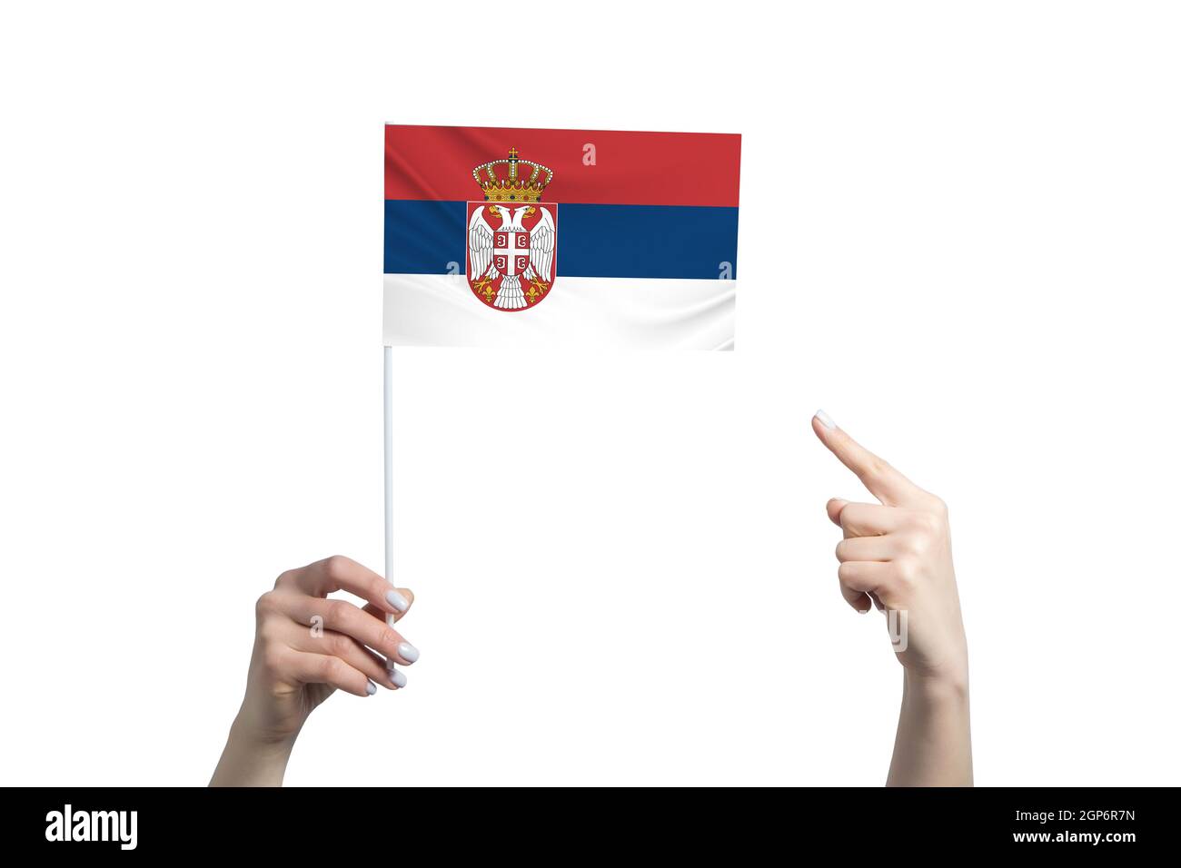A beautiful female hand holds a Serbia flag to which she shows the ...