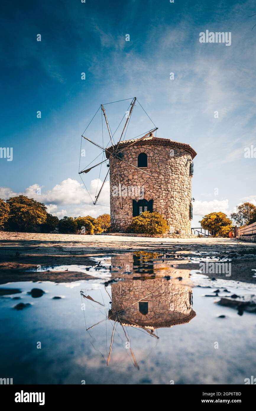 Ancient Greek stone windmill reflected in the water, Potamitis Windmill ...