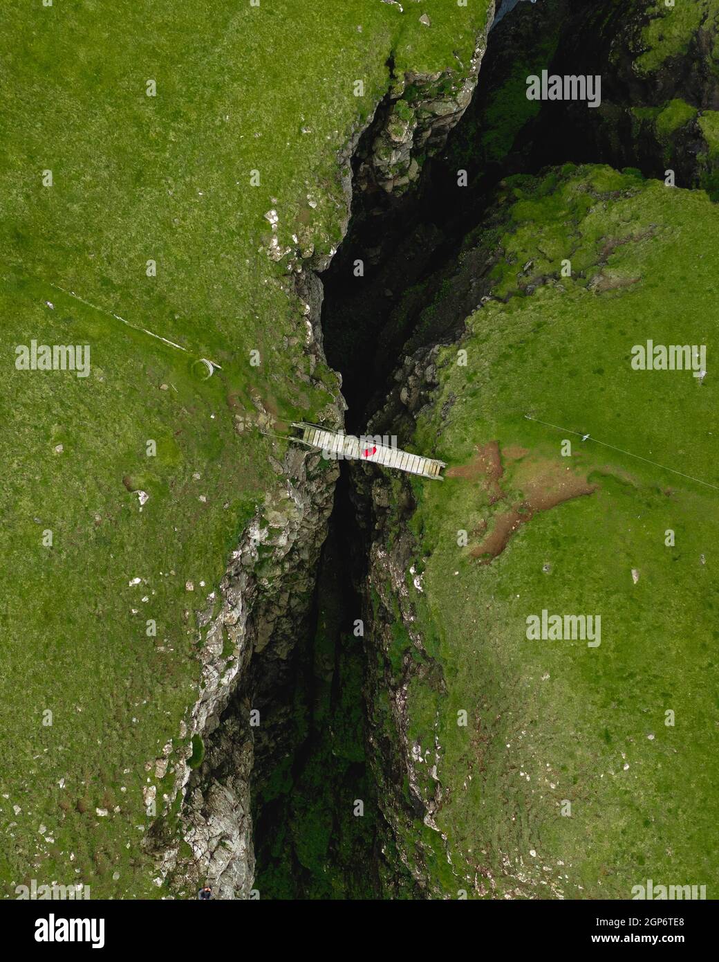 Aerial view, a person standing on a small wooden bridge, Sandvik ...