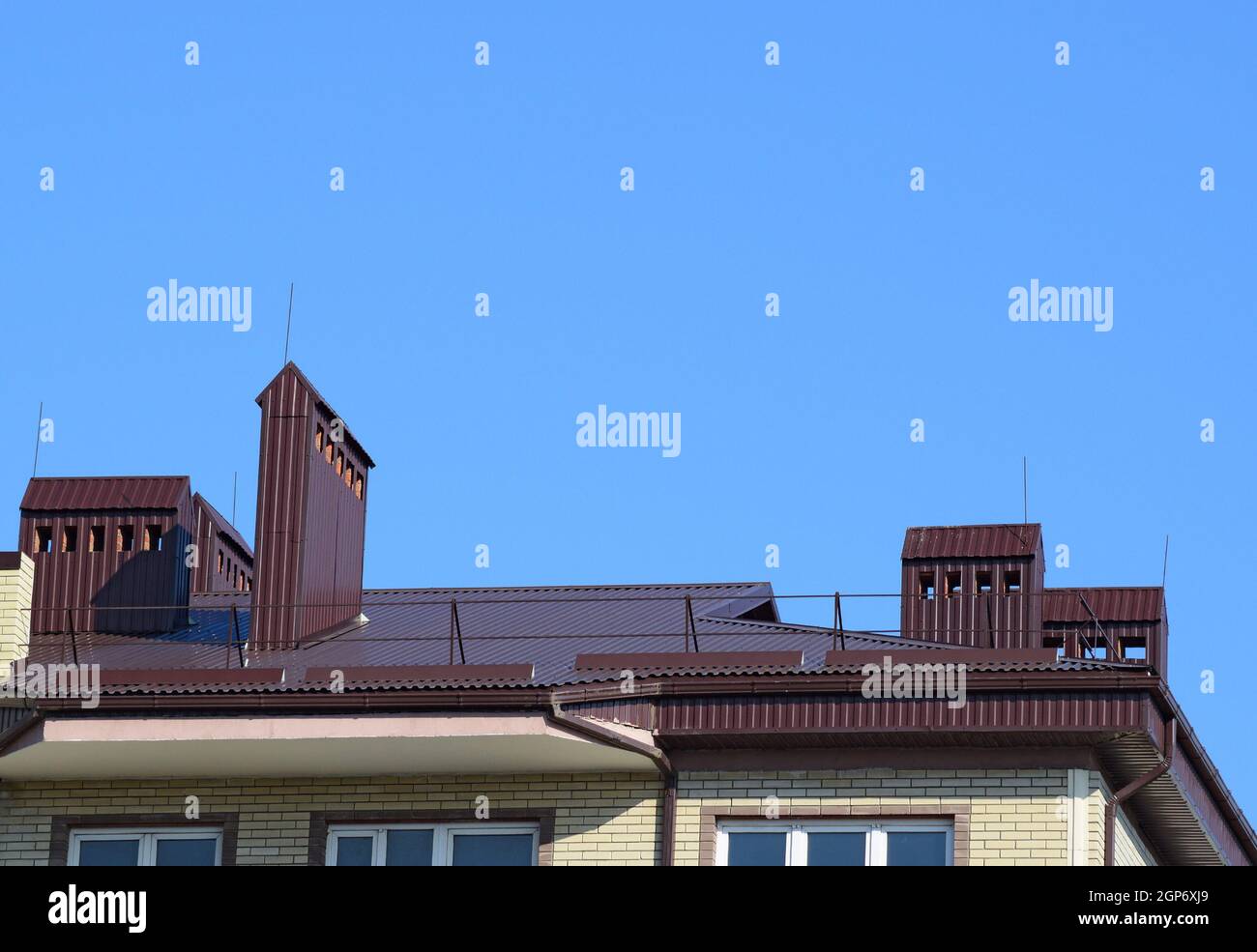 The roof of a multistory building. The roof of the metal sheets ...