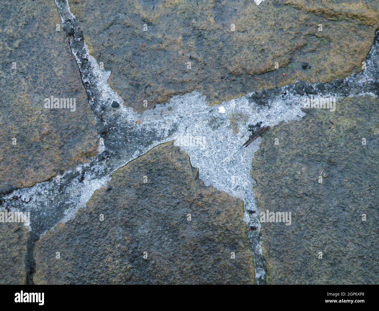 Frozen ice between stones. Sandstone stone background Stock Photo - Alamy