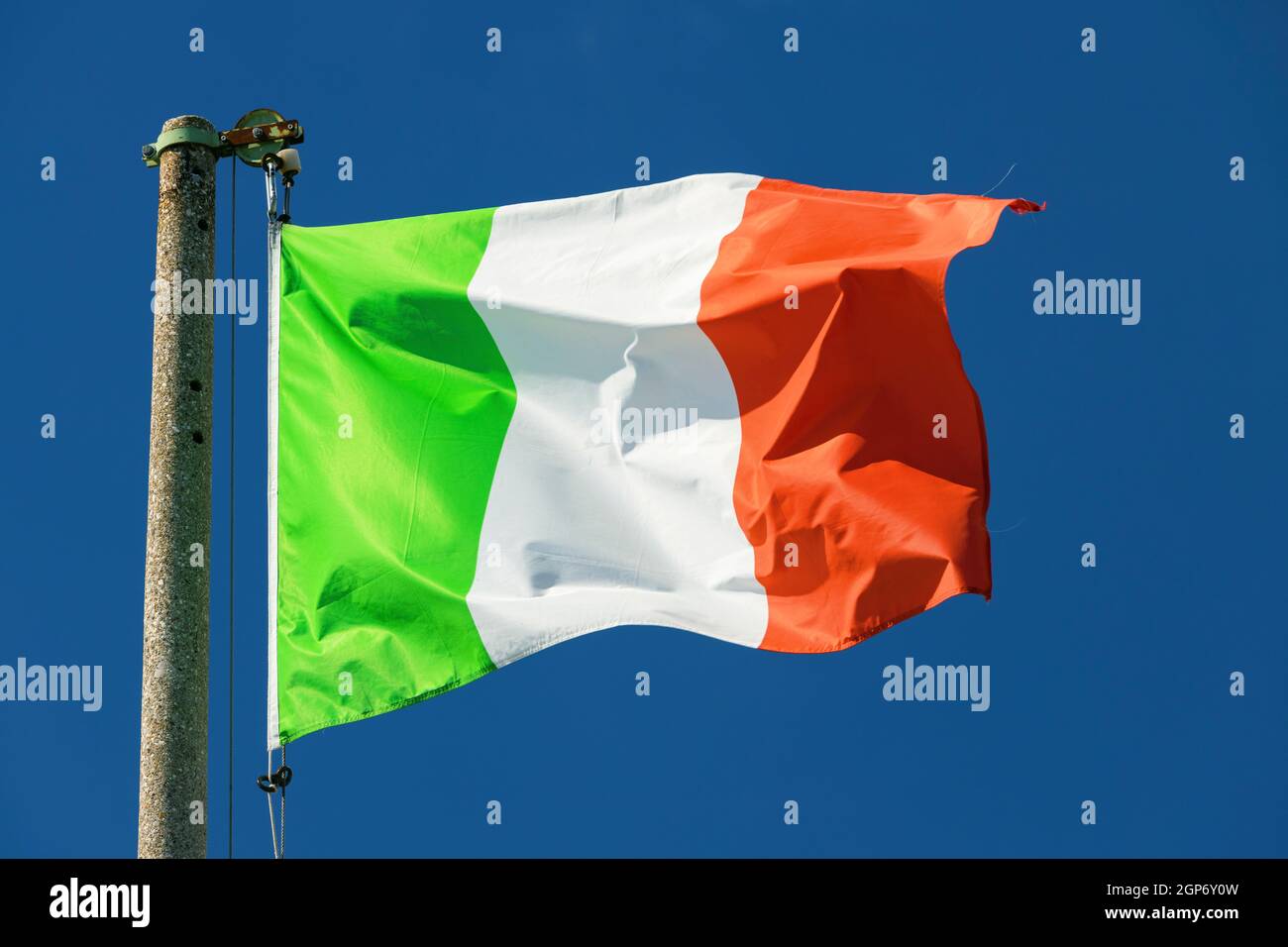 Italian flag blowing in the wind in the blue sky Stock Photo - Alamy