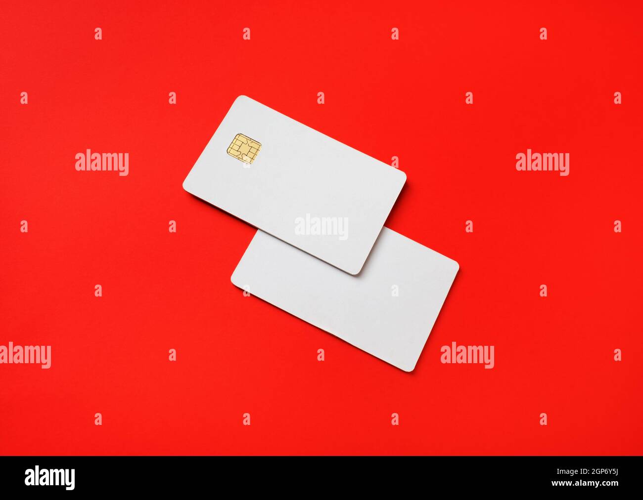 Photo of two blank credit cards on red paper background. White bank ...