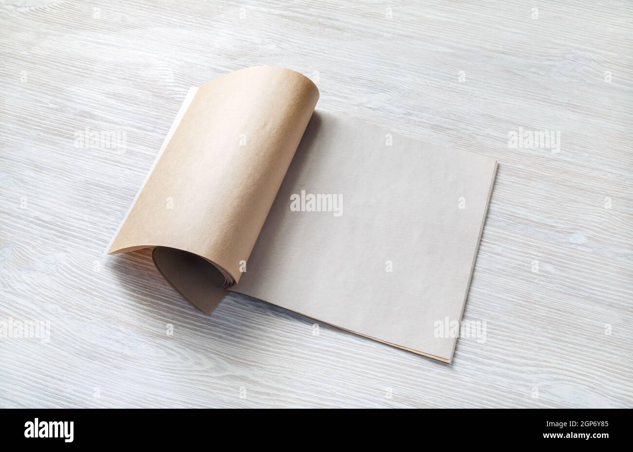Blank magazine template on wood table background. Responsive design ...