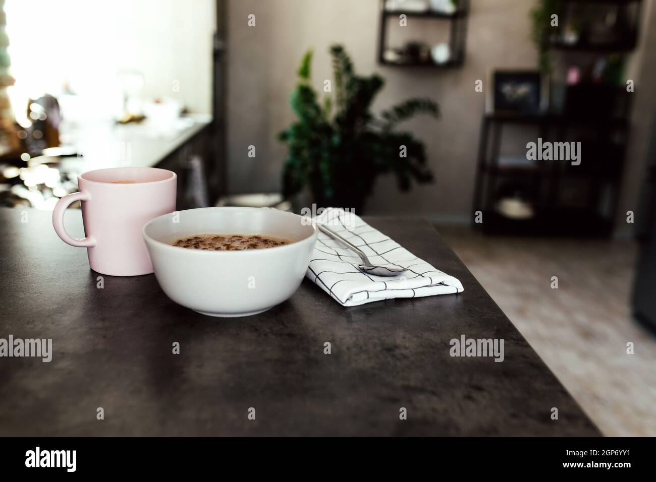Pink coffee cup, bowl with chopped tropical fruits kiwi and banana ...