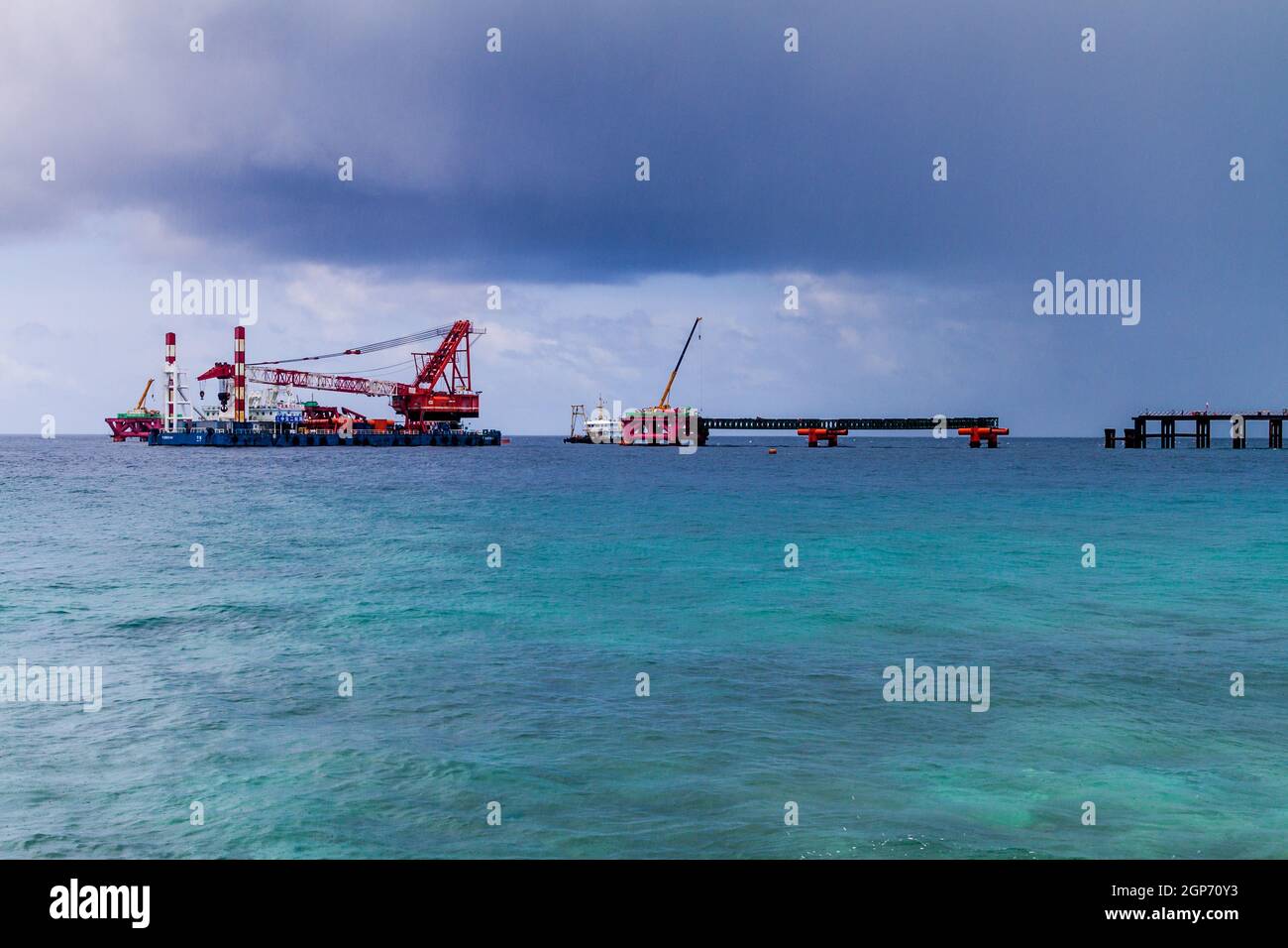 MALE, MALDIVES - JULY 11, 2016: Cranes building the connection of ...