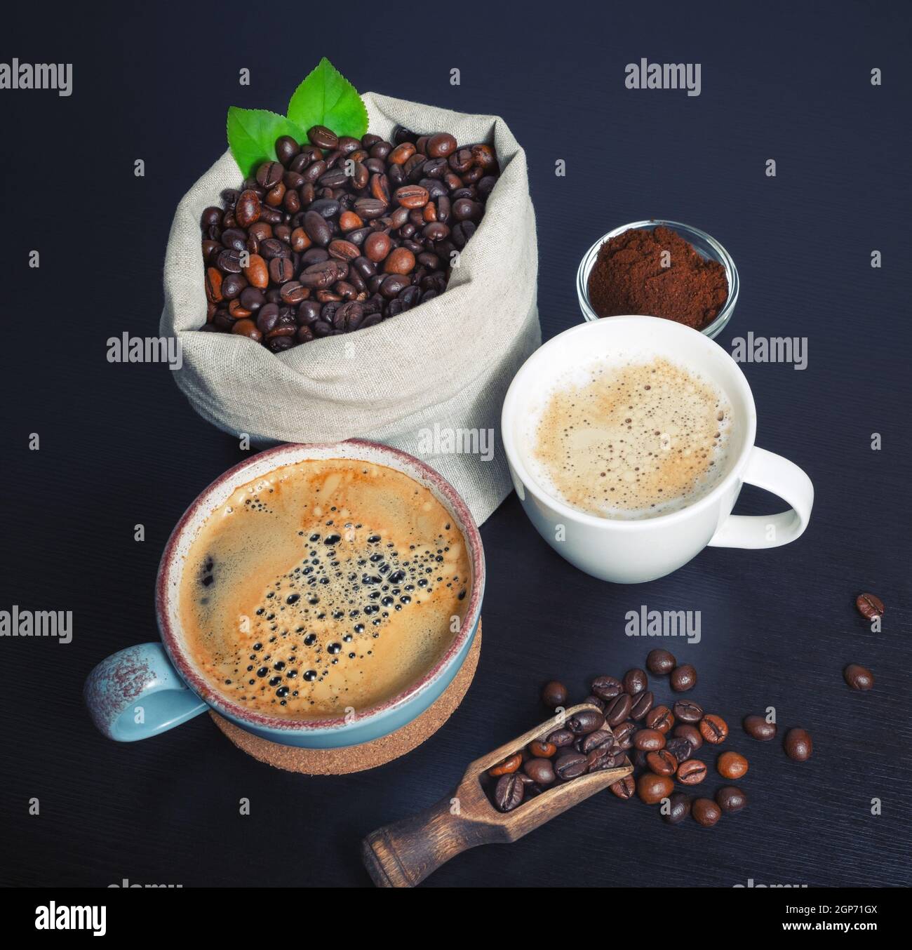 Delicious fresh coffee. Coffee cups, roasted coffee beans in canvas ...