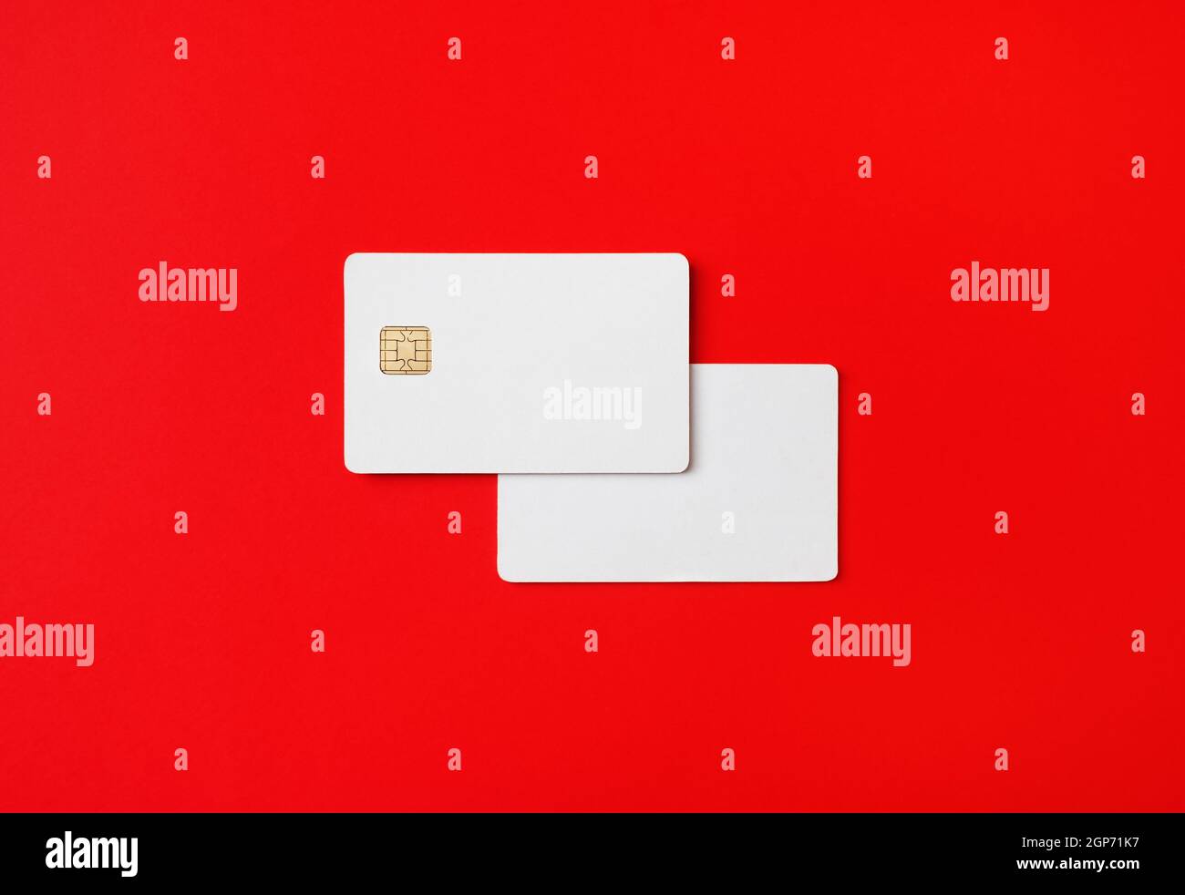 Photo of two blank credit cards on red paper background. White bank ...