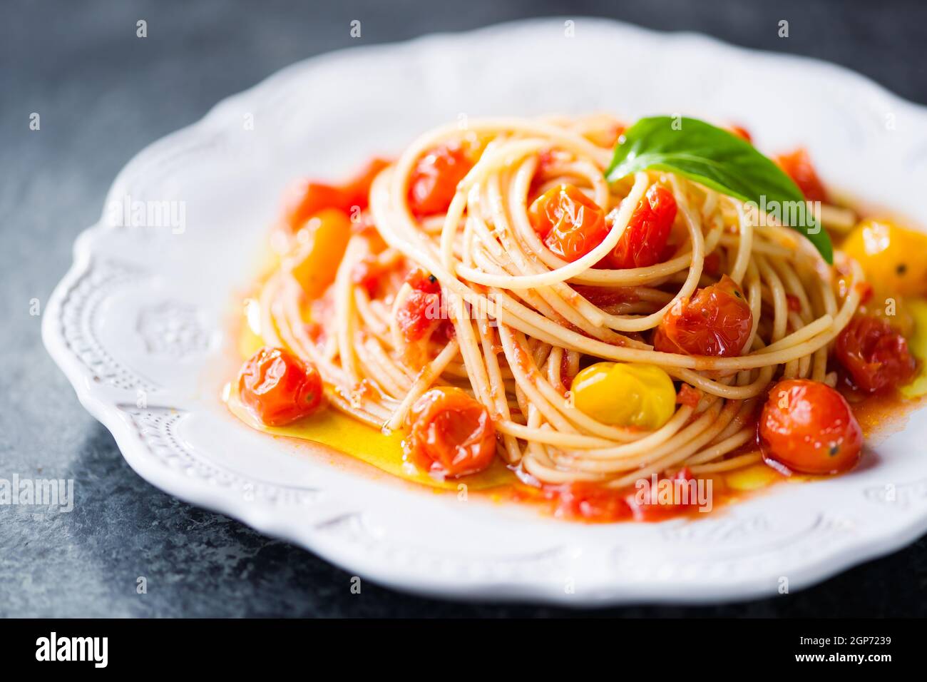close up of plate of rustic italian cherry tomato spaghetti pasta blur ...