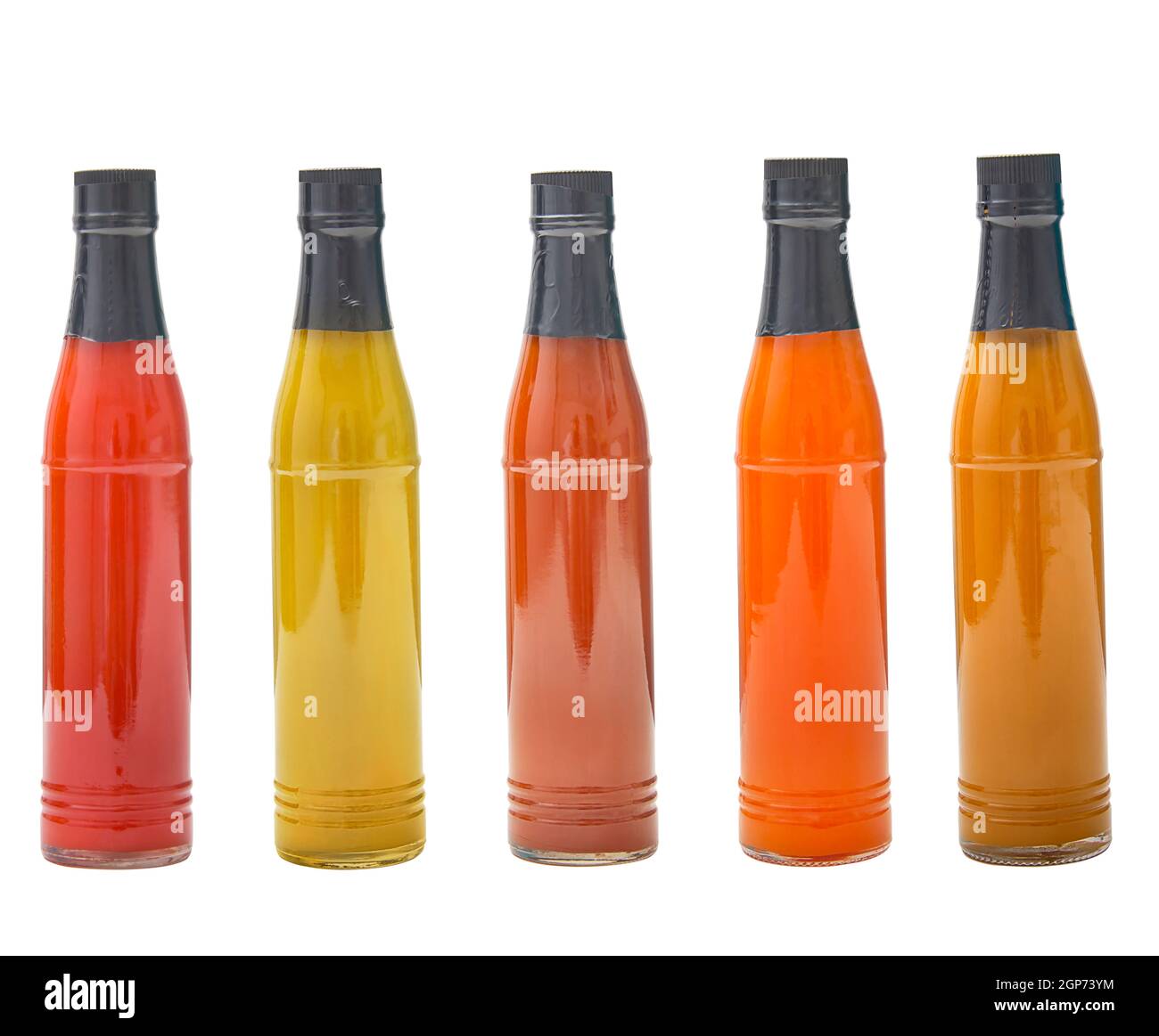 Set of glass bottles with different delicious sauces isolated on white ...