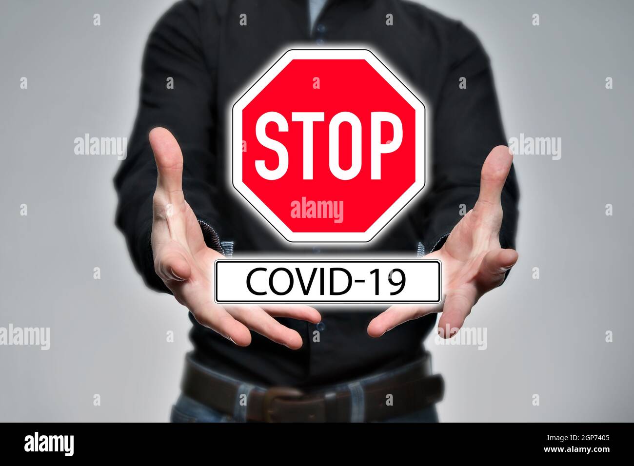 Man holding a Sotp sign in the hands, Stop COVID-19 Stock Photo - Alamy