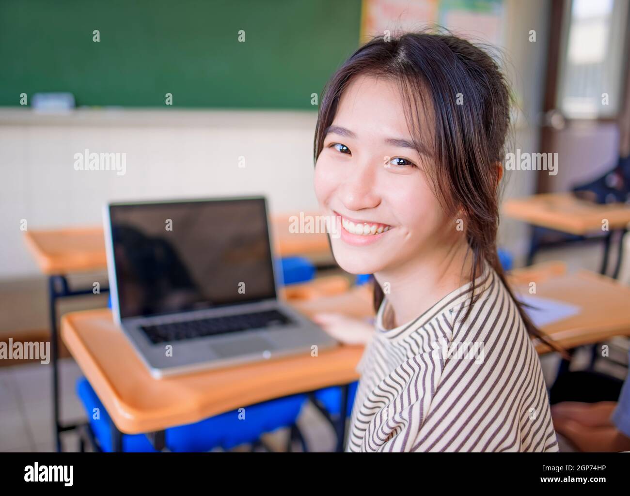 happy asian Student girl using laptop in classroom Stock Photo - Alamy
