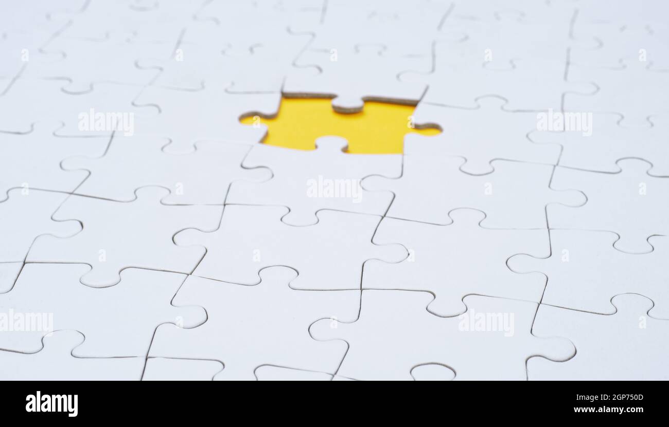 Empty white jigsaw puzzle with missing piece Stock Photo - Alamy