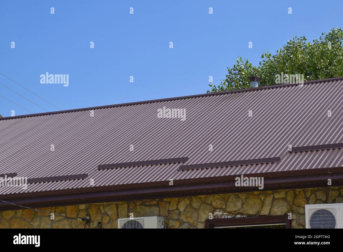 The roof of corrugated sheet. Roofing of metal profile wavy shape Stock ...