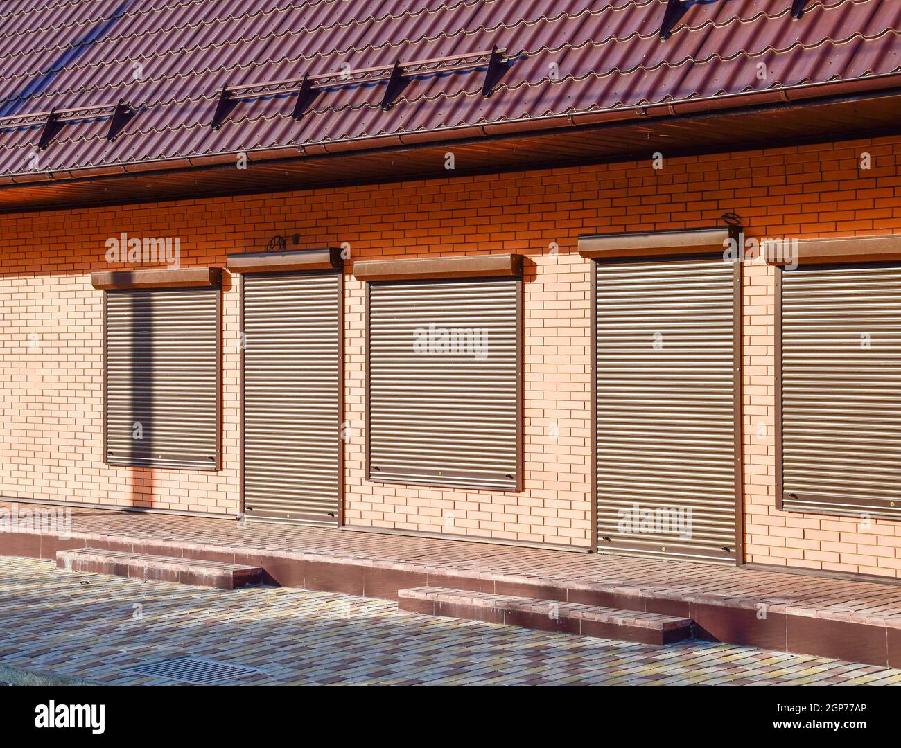 The roof of corrugated sheet on a building. Brown roofing metal sheets ...