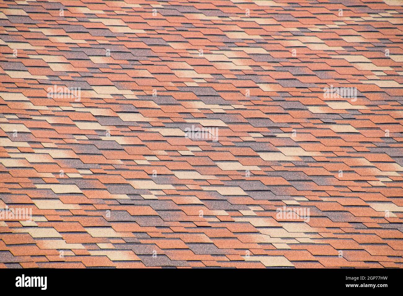 Roof from multi-colored bituminous shingles. Patterned bitumen shingles ...