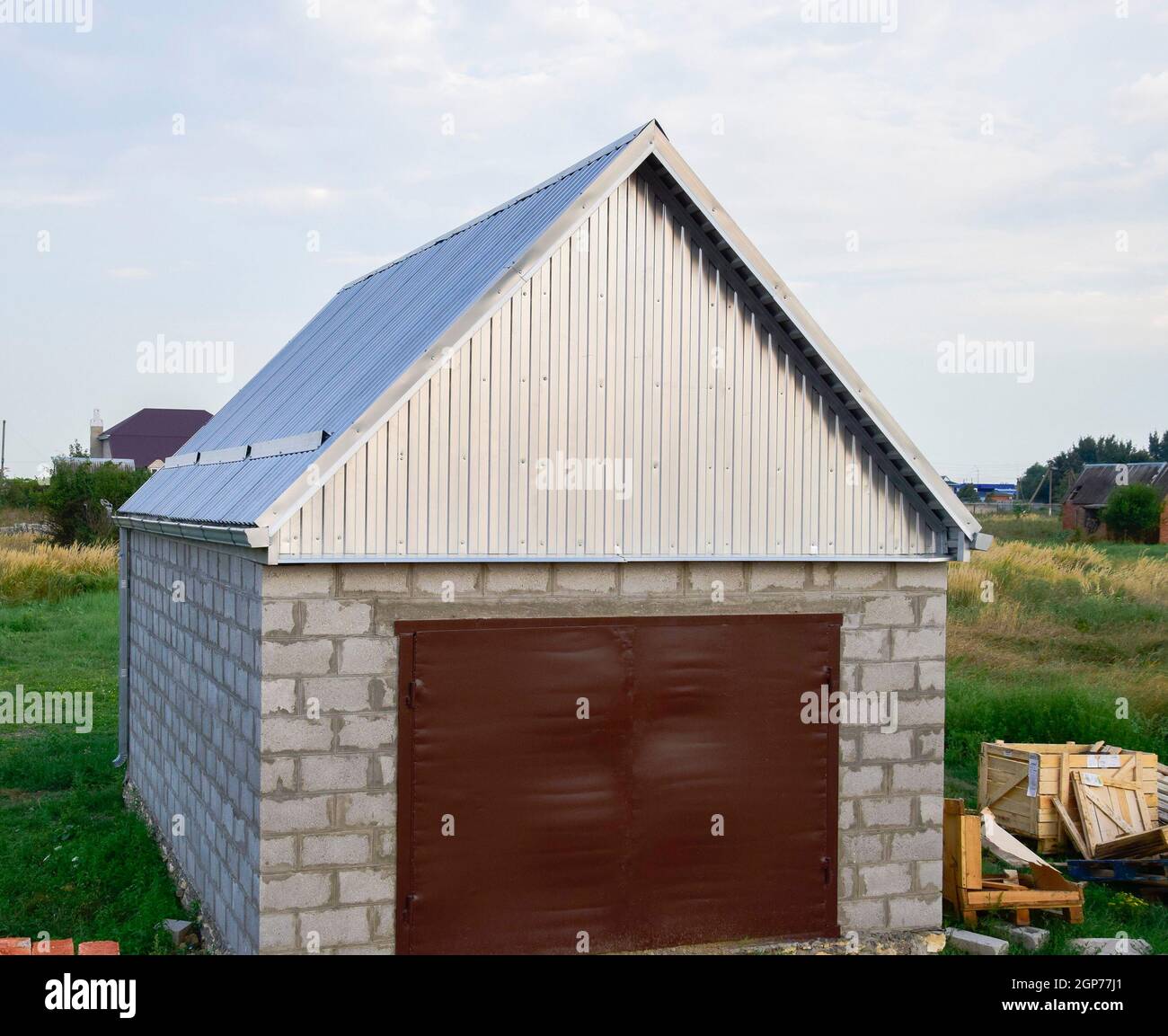 Small garage with a roof of corrugated sheet metal. Garage with steel ...